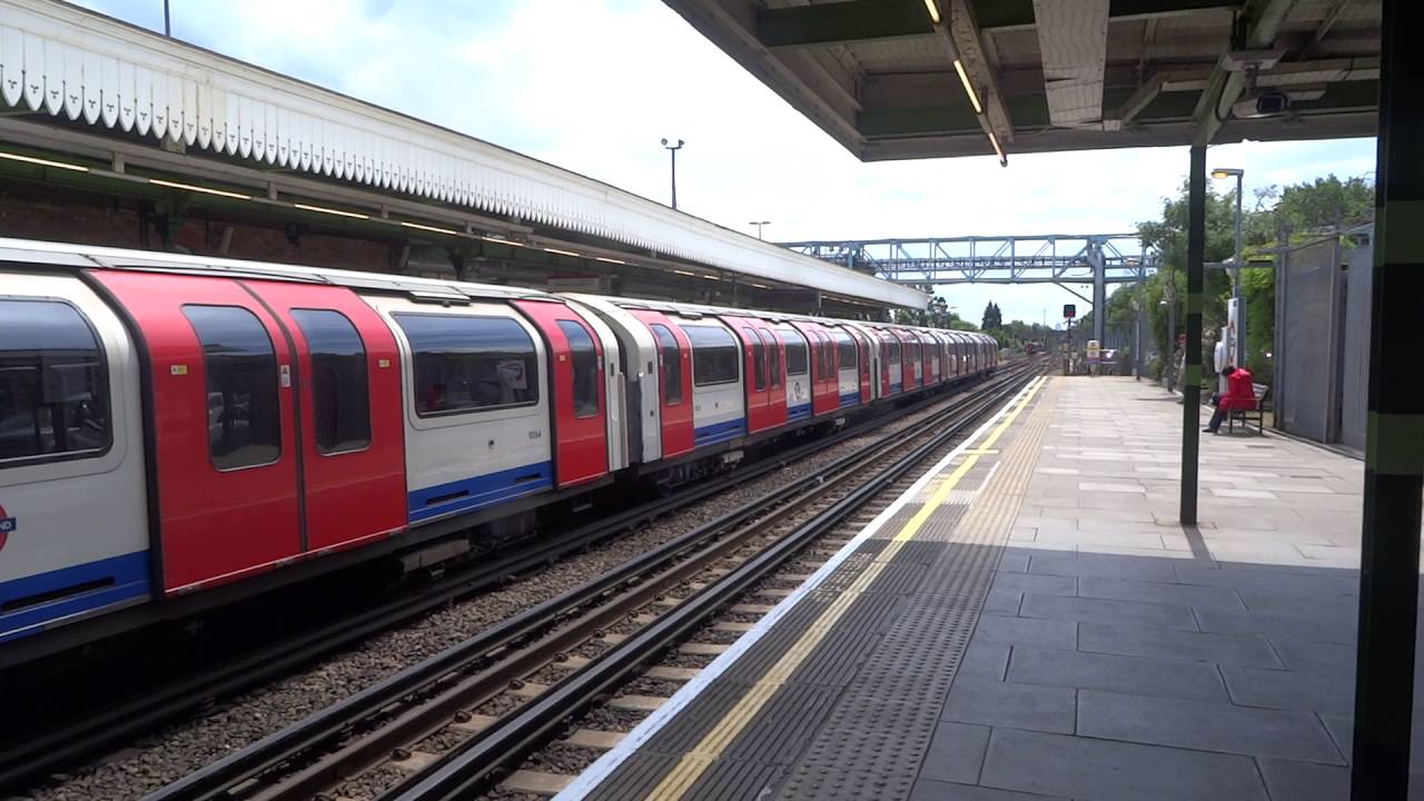 Central Line train arriving and departing Woodford - YouTube