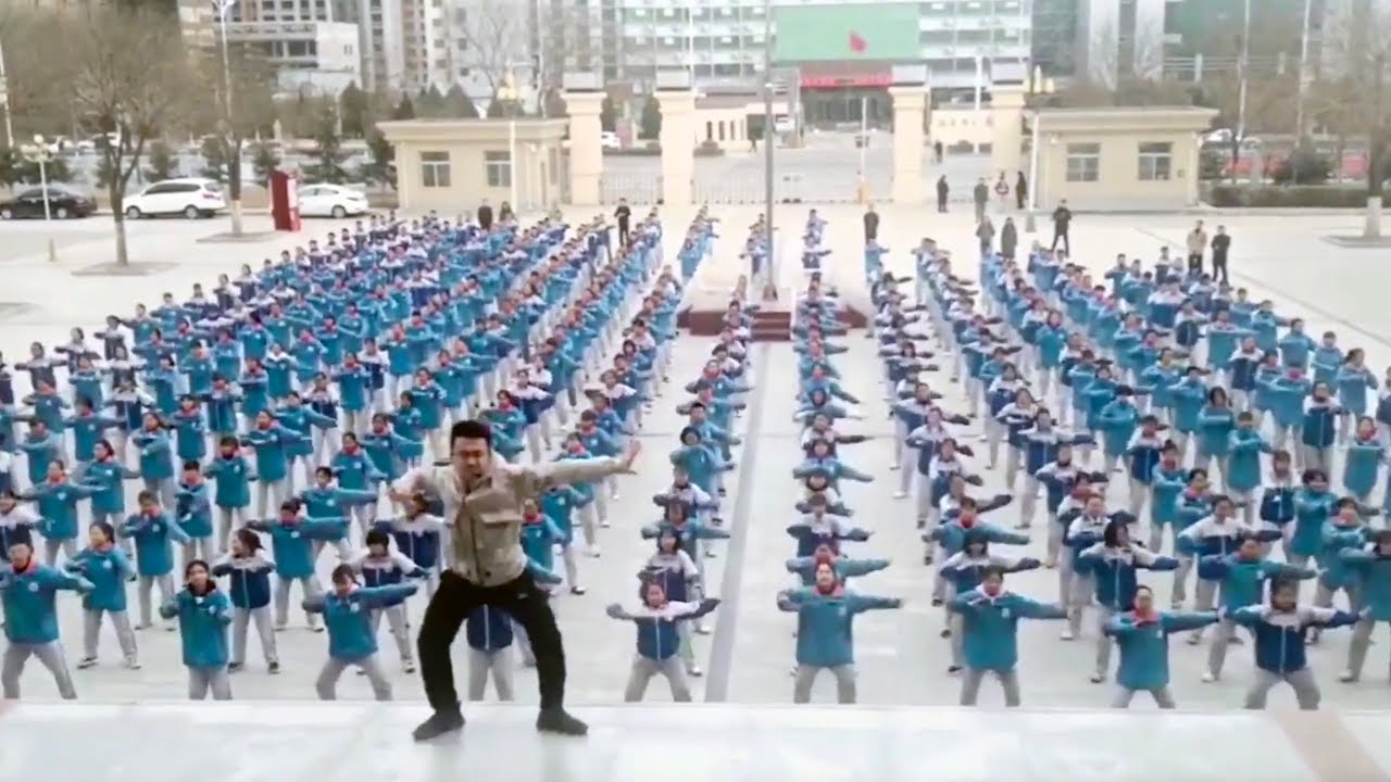 PE teacher choreographs dance routine with hundreds of students - YouTube