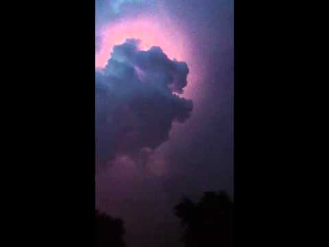 An angry looking God coming out of the clouds in a lightning storm ...