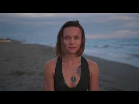 Woman practice yoga on the beach in the sunset. (Stocksy United)