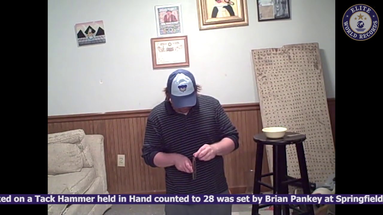 Tallest Penny Tower Stacked on a Tack Hammer held in Hand EWR201120379 ...