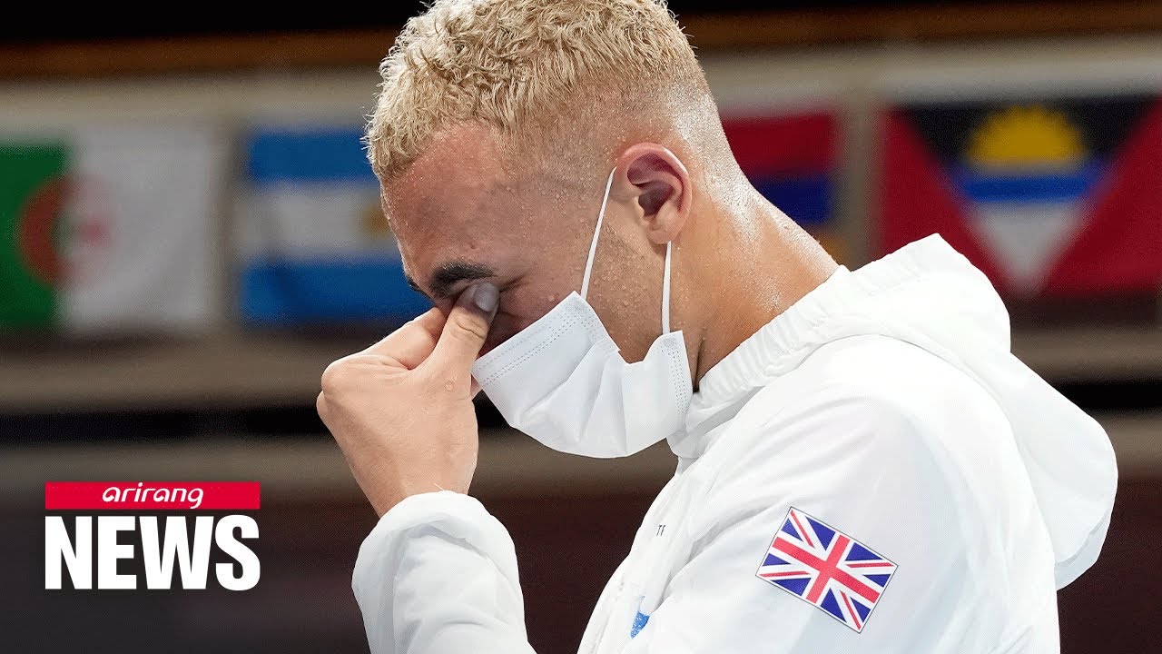 British boxer Benjamin Whittaker skips wearing his silver medal out of ...