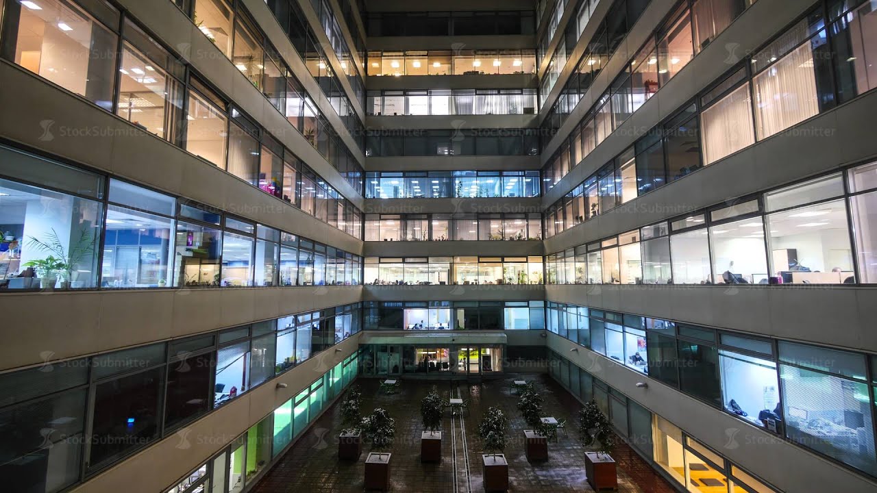 Time lapse of busy city office workers together in large modern office ...