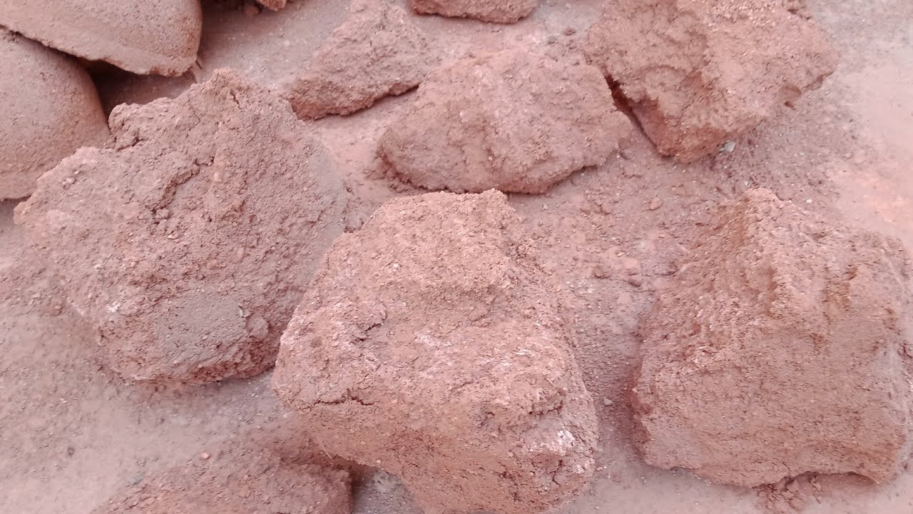 Fast version grainy Red Dirt chunks and shapes crumble dipping in water ...