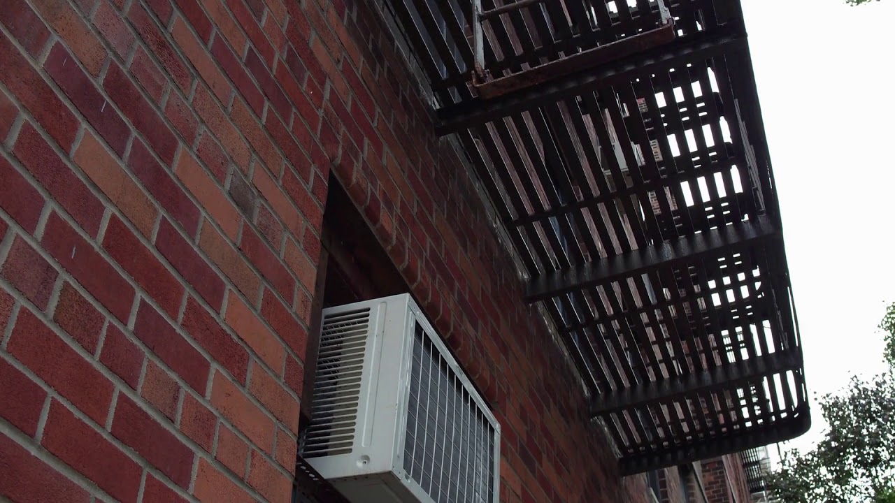 air conditioner under fire escape of exterior apartment complex - YouTube