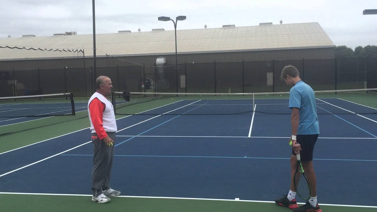 Usta National coach Andy Brandi working with Pierce Rollins on one of ...