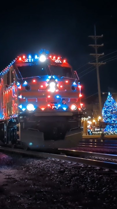 Metra's 2024 holiday train passes by a Christmas tree! #metra #chicago #shorts #fyp #railfanning ...
