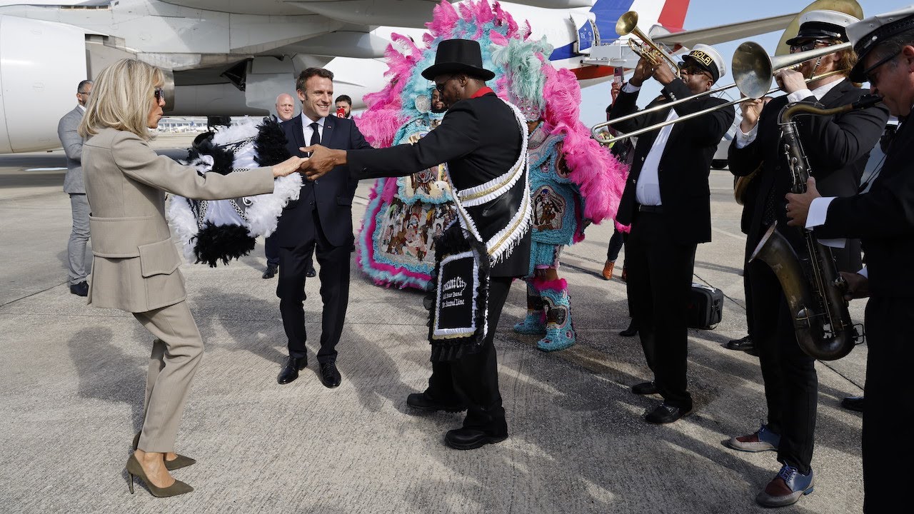 French President Macron dances as he arrives at the airport in New ...