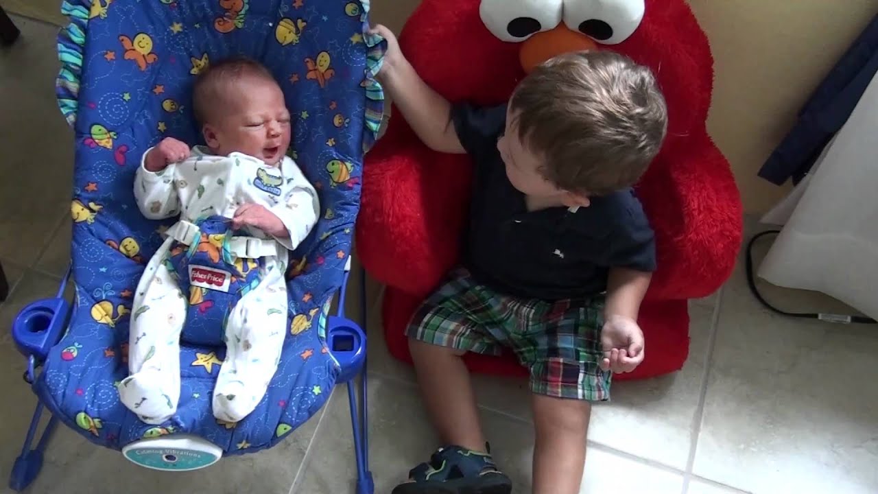 Cameron in Elmo chair rocking Cole - YouTube