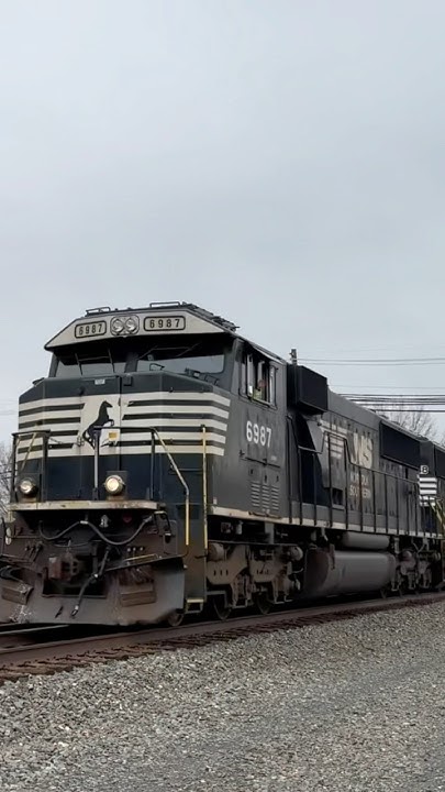 NS 6987 SD60E leads NS H76 through Manville NJ with friendly crew and NS 6348 trailing 3/22/2025 ...