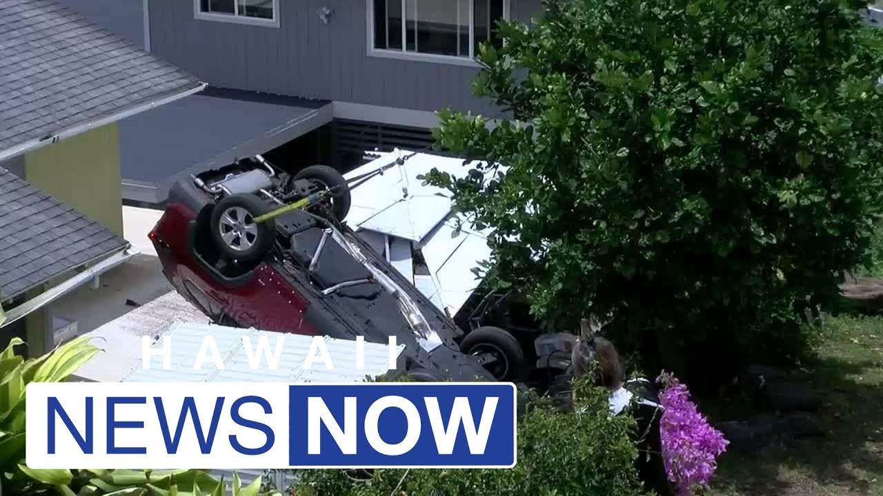 Woman in serious condition after car drives off ledge, lands on home’s ...