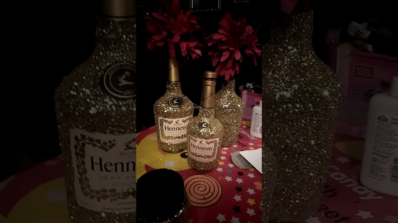 Party table decorations made from old Henny bottle,glue, glitter ...
