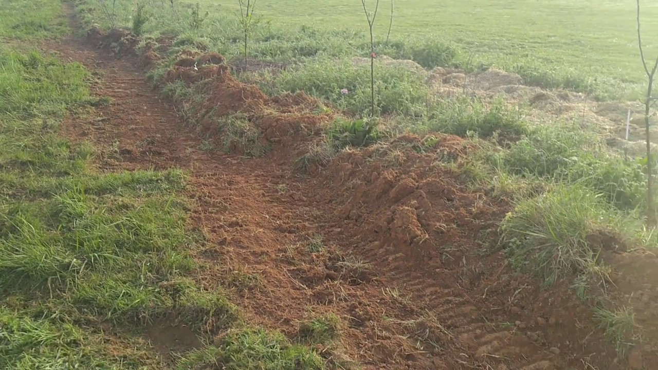 Micro swales with bobcat on Permaculture farm - YouTube