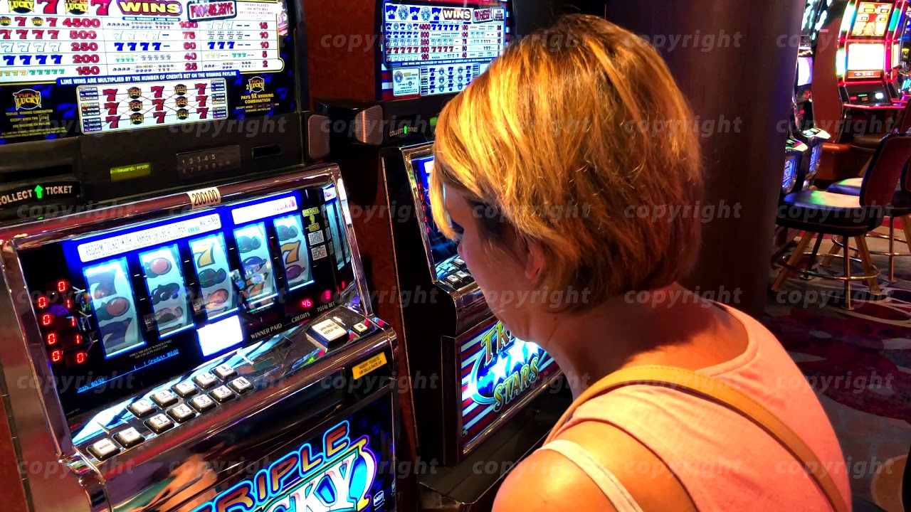 Woman playing slot machine in casino - YouTube