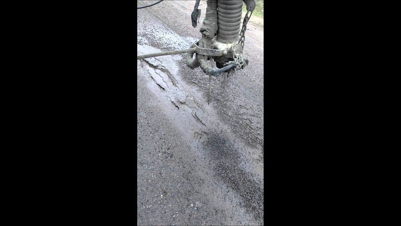 Spray patching road - YouTube