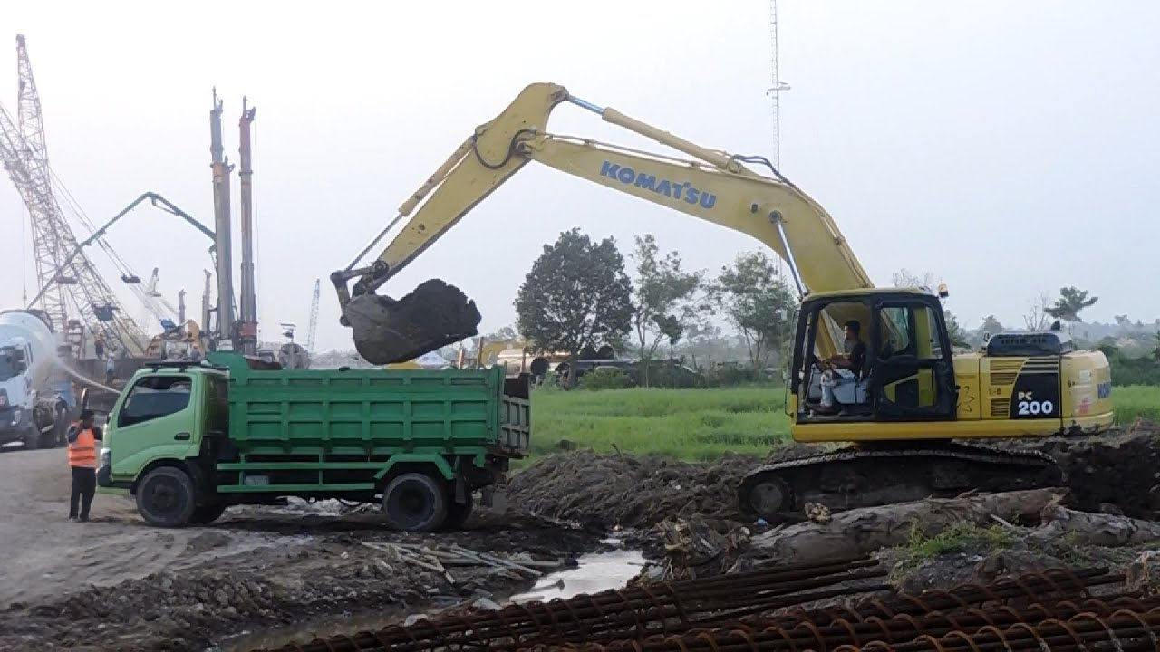 Sany SR 155 Rotary Rig is drilling for bridge pylons. Komatsu PC 200 ...