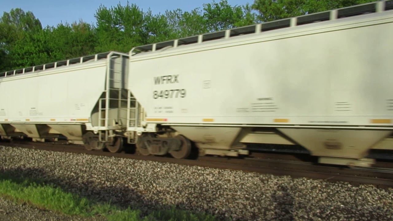 CN 2343, 2204 speeding with an Eastbound WFRX covered hopper freight ...