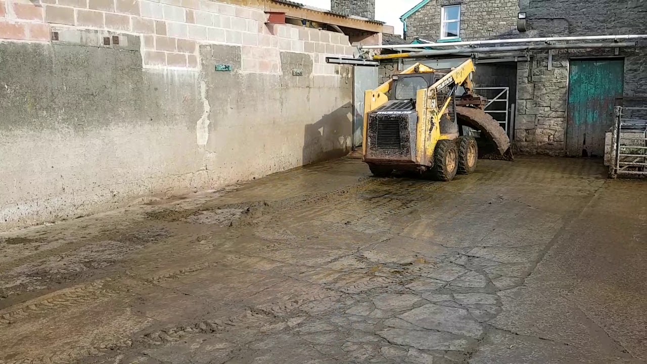 Mensch Slurry Scraper on Skidsteer - YouTube