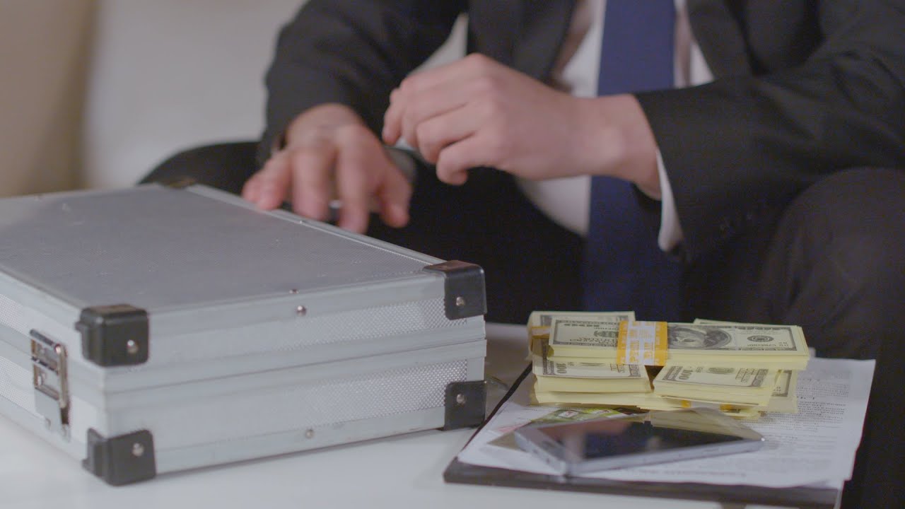 Businessman takes out dollar packs from briefcase, lots of money. Stock ...