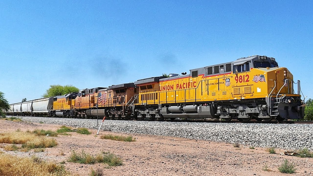 Rebuilt Union Pacific dash 9 and GP38N lead a freight train - YouTube