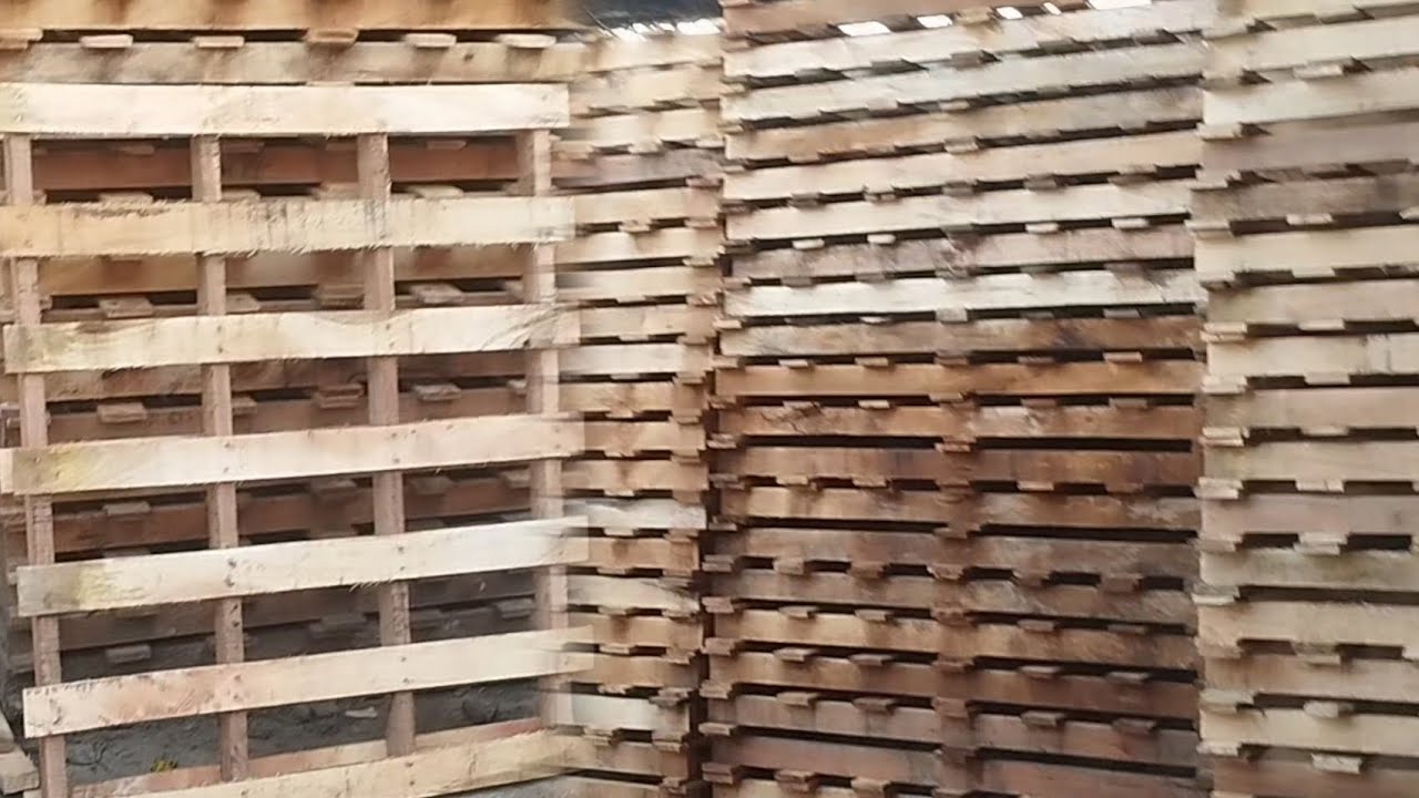 The process of making mass-production of wooden pallets. Pallet factory ...