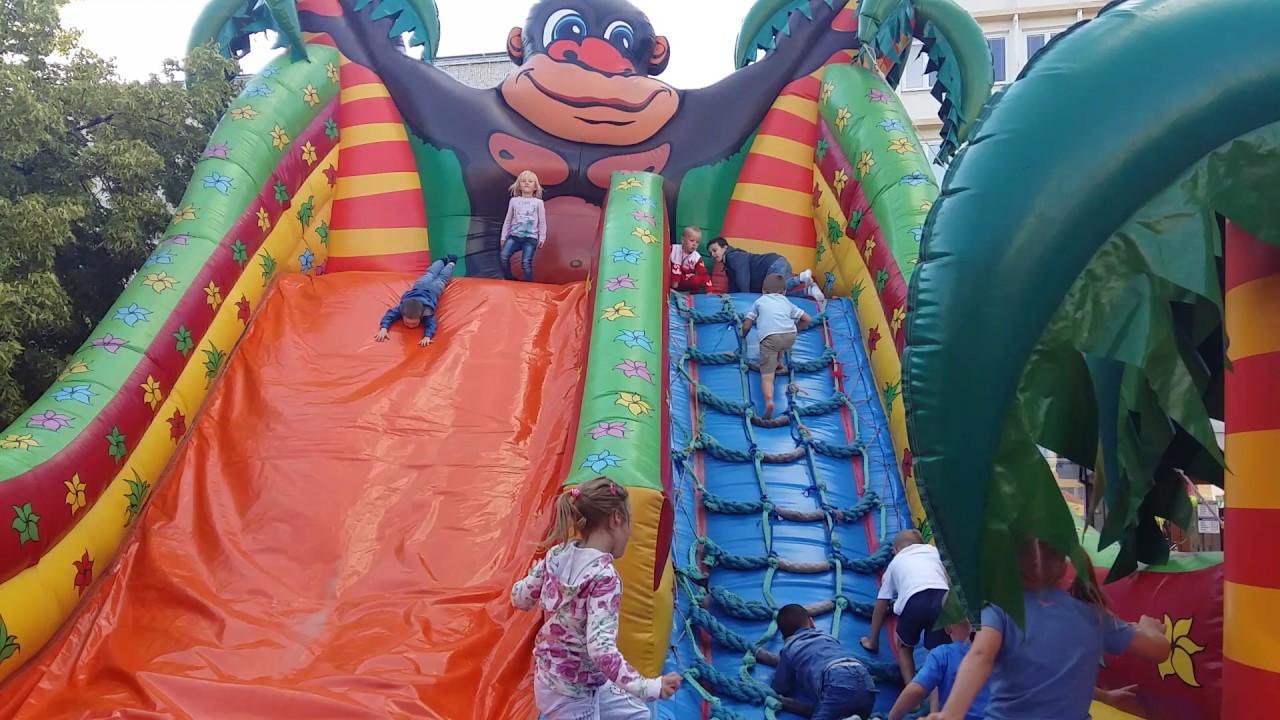 Children having fun on giant inflatable monkey slide - YouTube