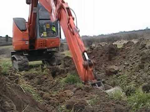 hitachi mini digger at work trenching 2011 - YouTube