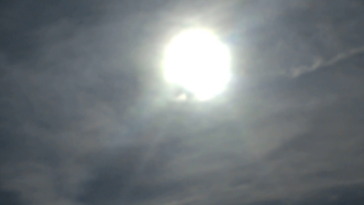 Piece of the sun breaks off while upper left of sun exposes blue - YouTube