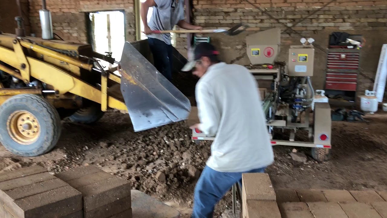 AECT 2001A Impact making 300 compressed earth blocks per hour - YouTube