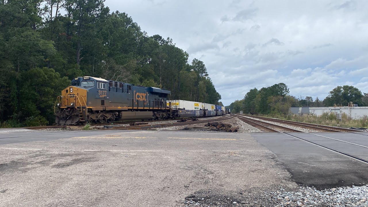CSX 2 train meet at a turnout, long cut of OJ cars on a CSX train. # ...