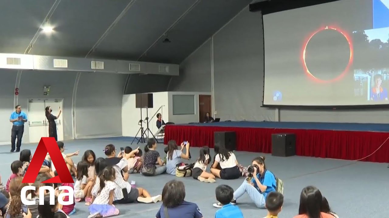 Rainy skies cloud rare solar eclipse viewing in Singapore - YouTube