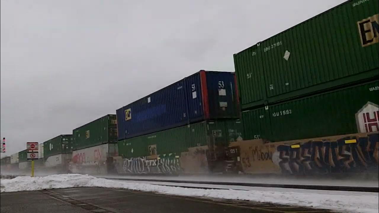 CN 148 w/ CN Engines 2255 & 2945 lead this long 484 axle, EB Intermodal/Autorack train by ...