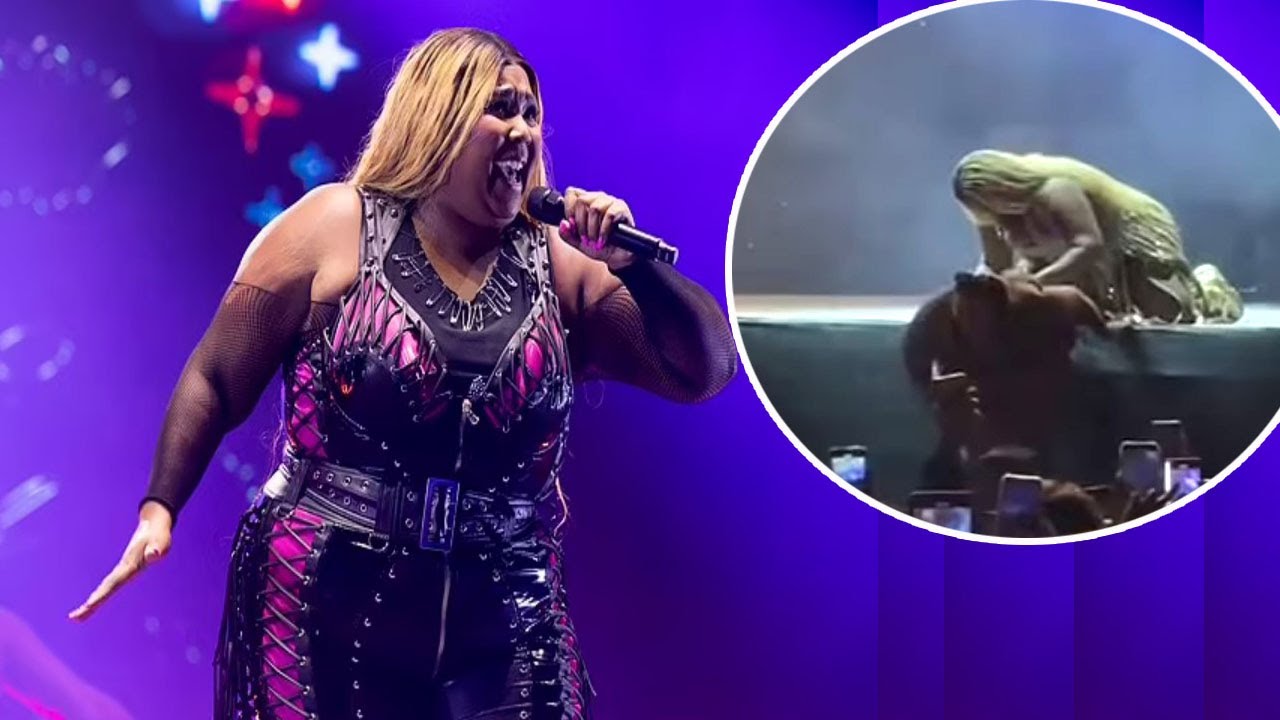Lizzo signs the bottom of a female fan during a mid-performance at ...