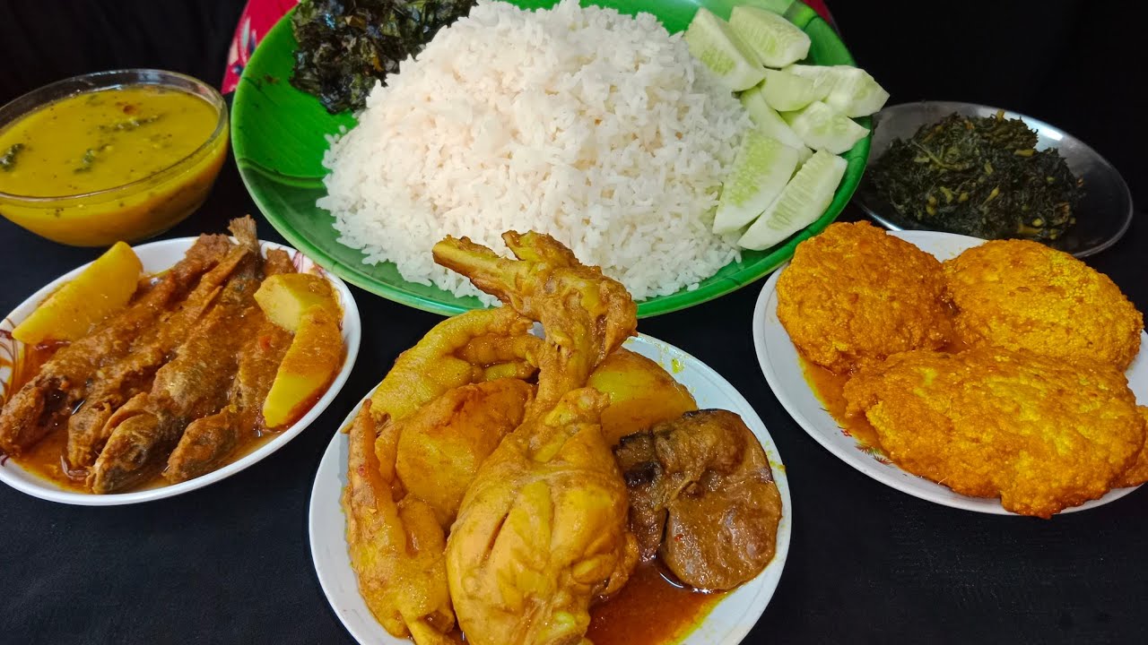Eating Rice with spicy chicken curry vegetable fish curry fish egg ...