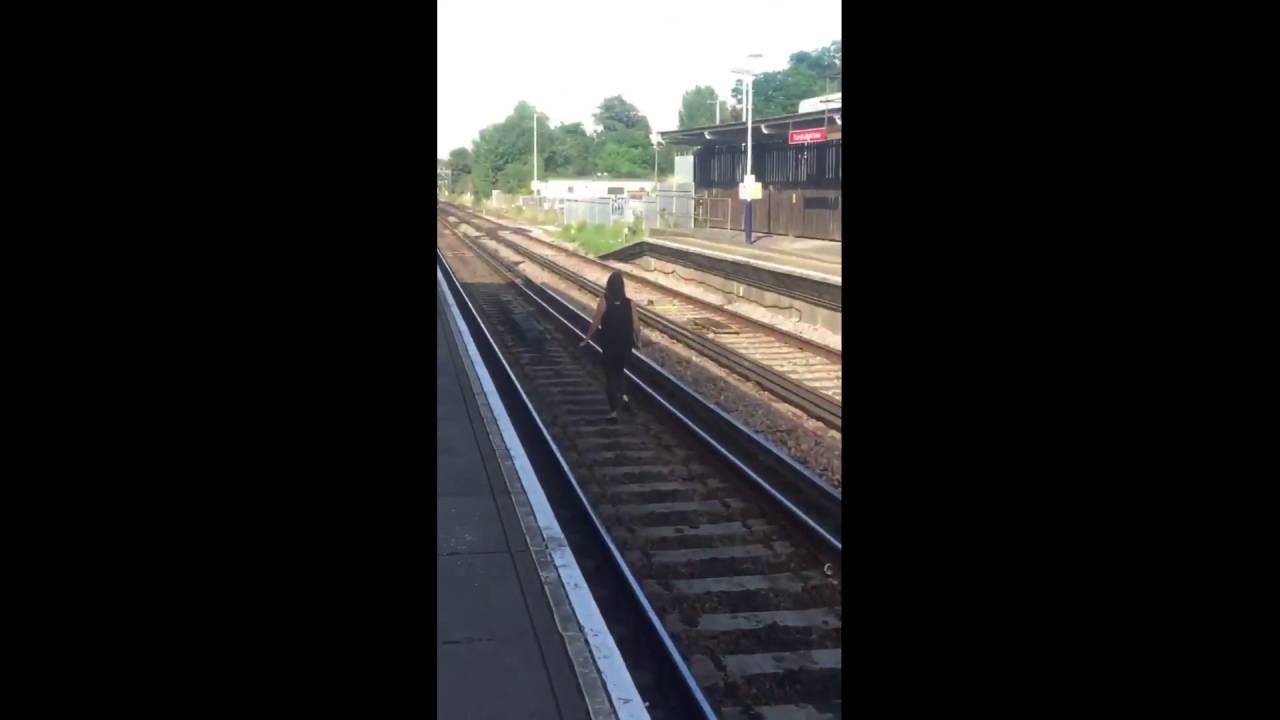 Shocking moment woman is spotted walking on Woking train tracks - YouTube