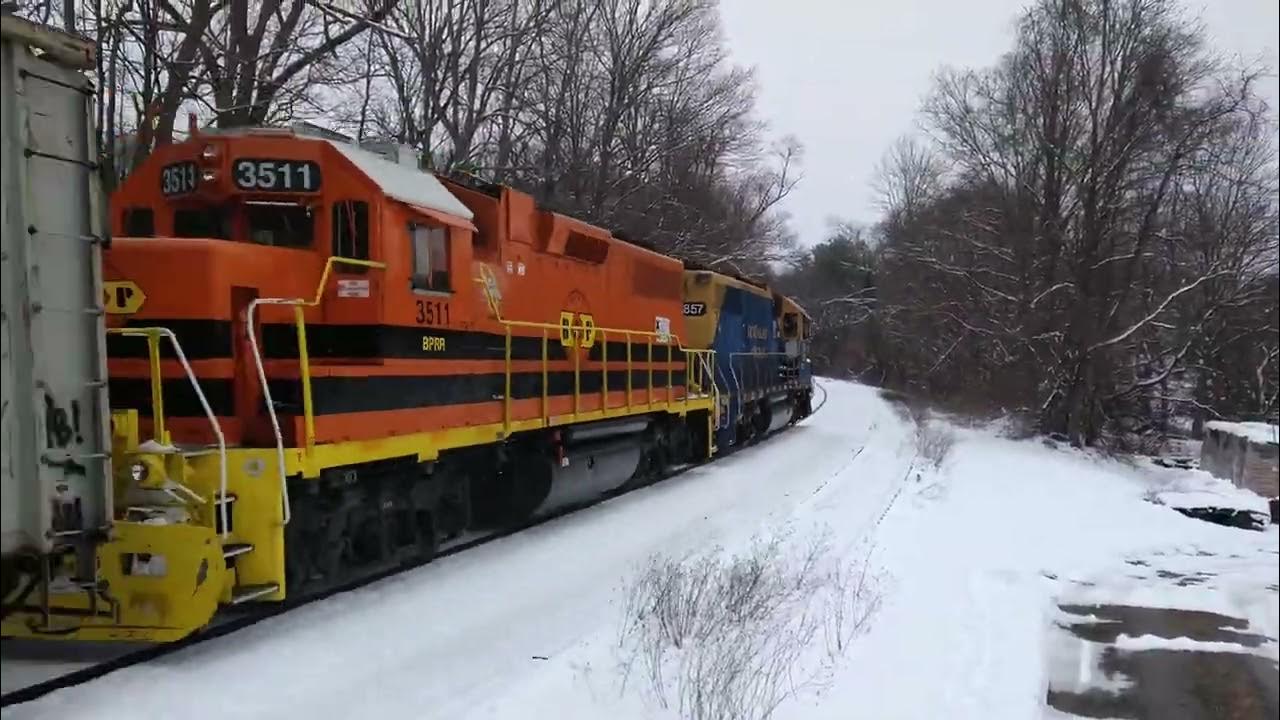 Genesee and Wyoming New England Central 608 speeds south in snow in Mansfield Depot Connecticut ...