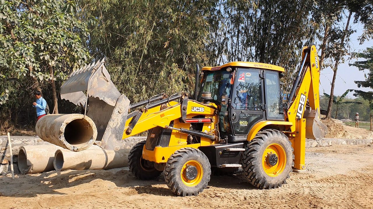 JCB Backhoe Loader Lifting Heavy Culvert Pipe and Installing in Drain ...