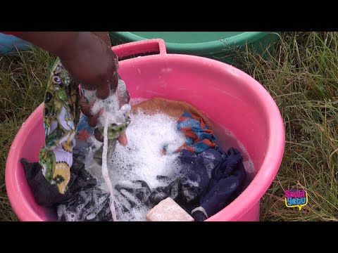 Women washing clothes at a stream in Kibera