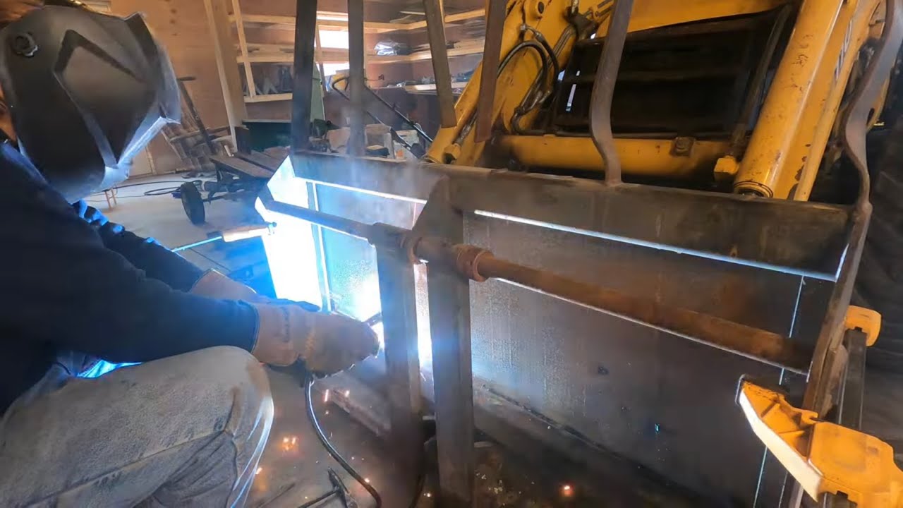 Welding up forks for the backhoe and then breaking them - YouTube