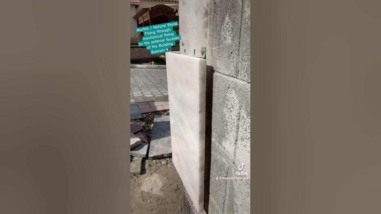 Marble stone mechanical fixing in the exterior facade of the building ...