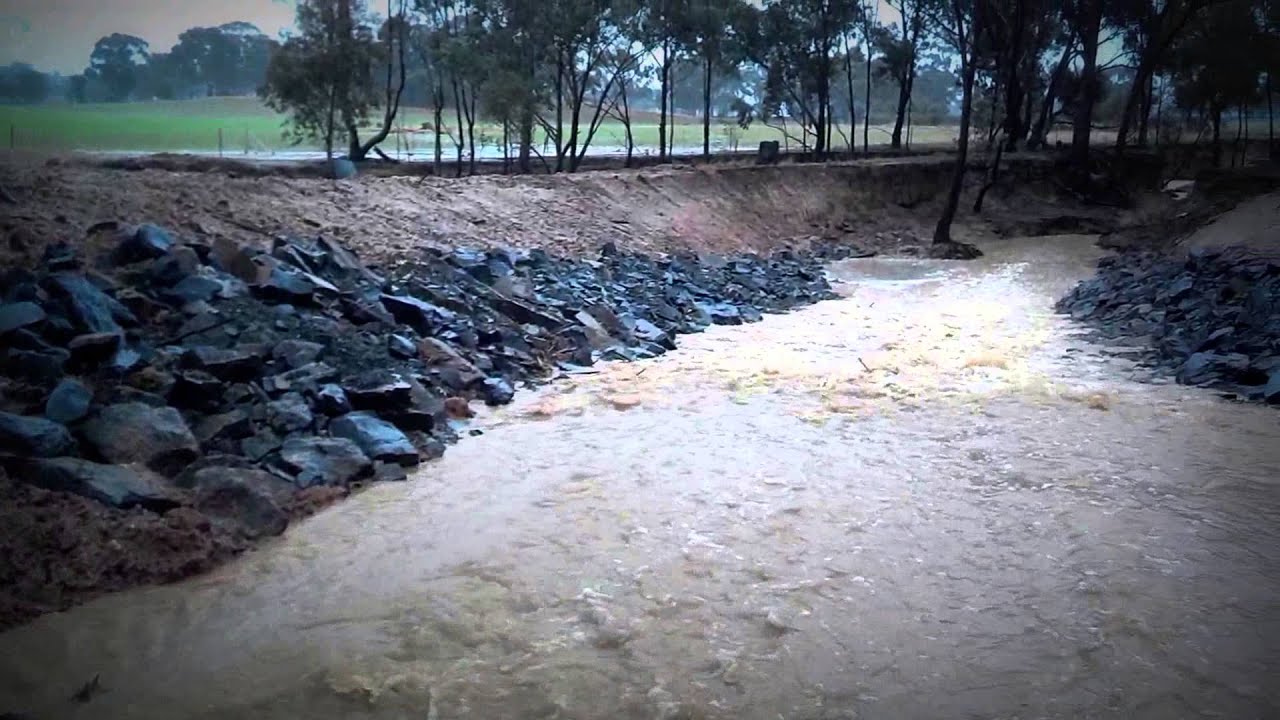 Completed engineered grade control structure with flow - YouTube