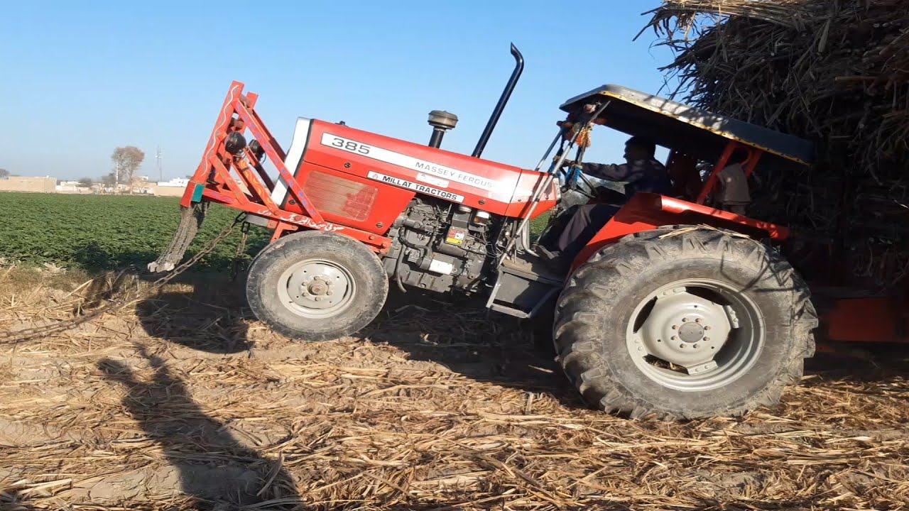 Massey 385 pulling sugarcane load trolley - YouTube