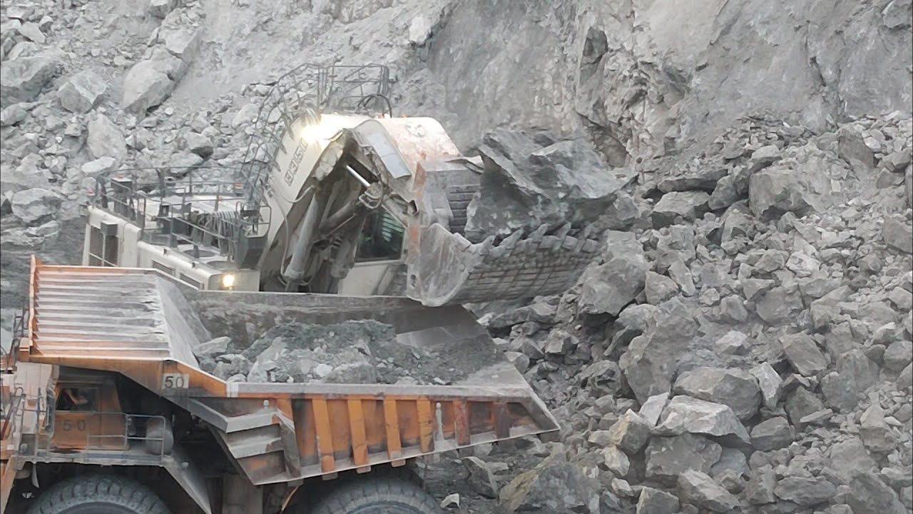 Loading Big Chunks of Rocks Liebherr R9350 Excavator Loading the Dump ...