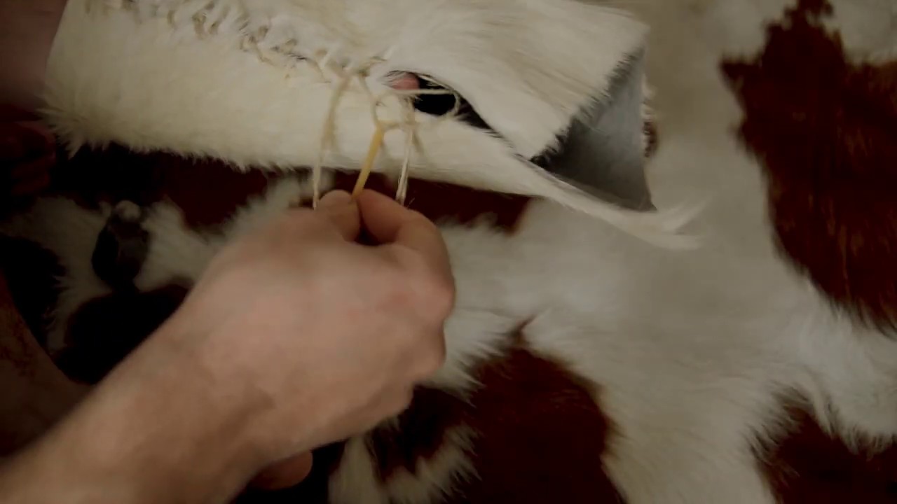 Sewing with palaeolithic bone needle - YouTube