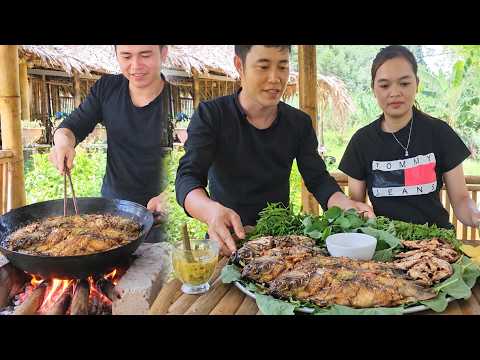 A whole fried fish prepared in a rustic, traditional style—cooked over a wood fire.