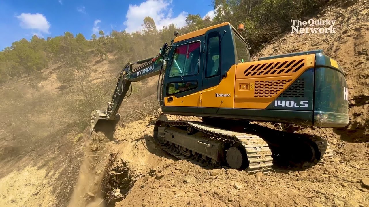 Excavator Operating on Extremely Dangerous Terrain for Road ...