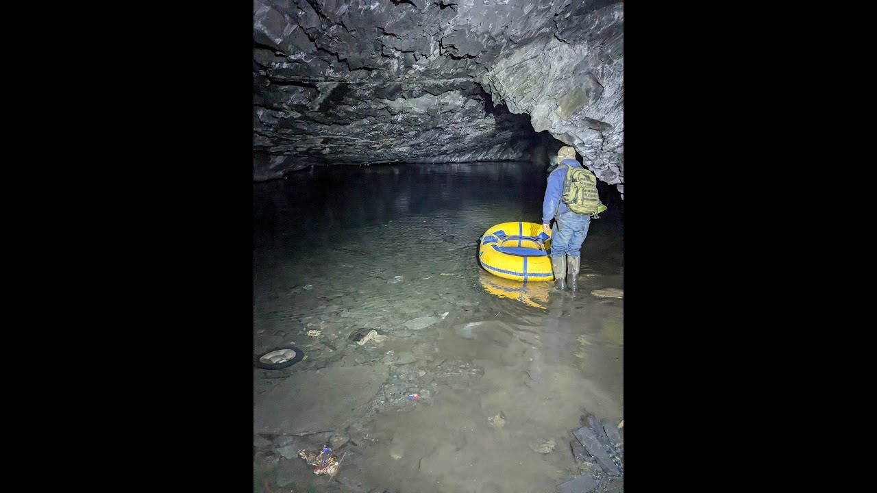 Rafting an underground lake while exploring the inside of an abandoned ...