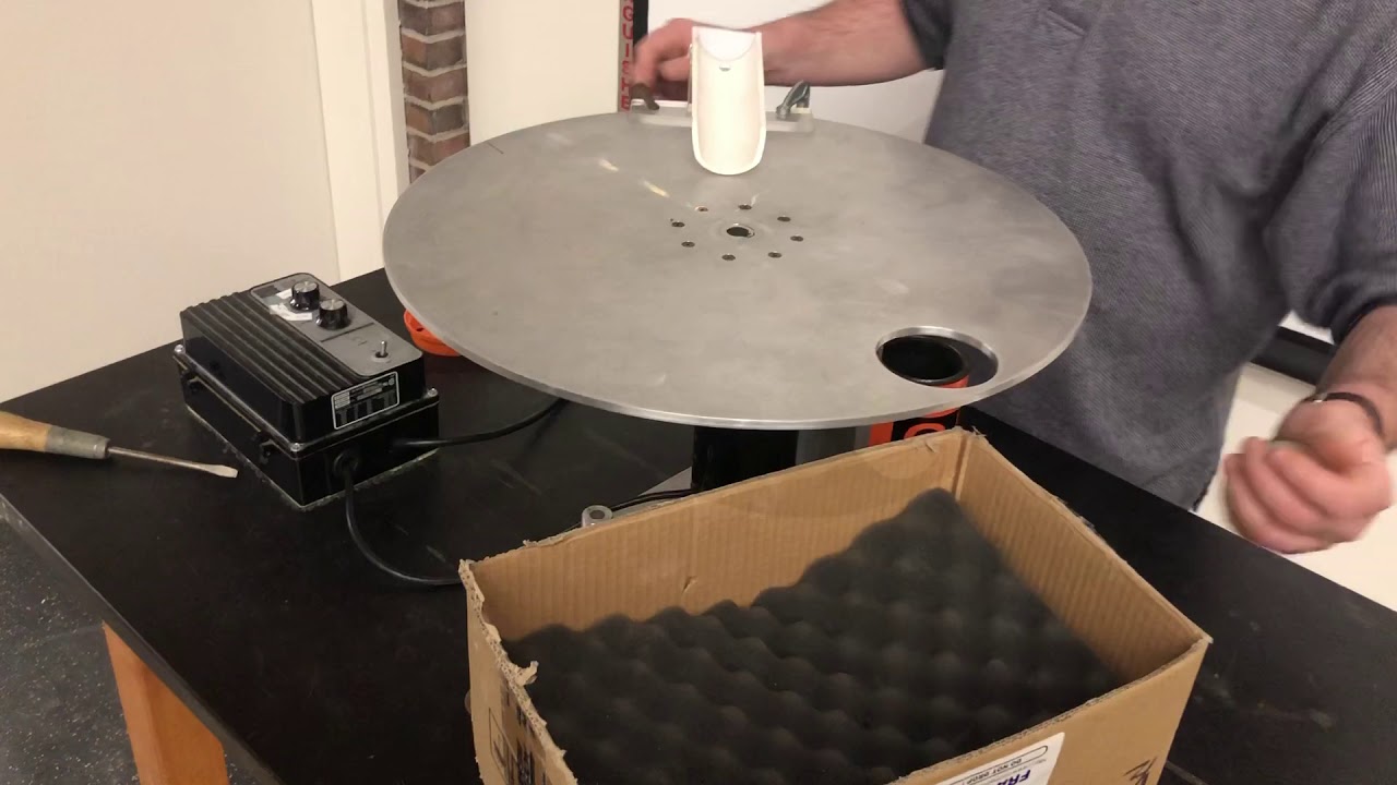 1E30.28 Ball on a Rotating Turntable with Ramp and Hole - YouTube