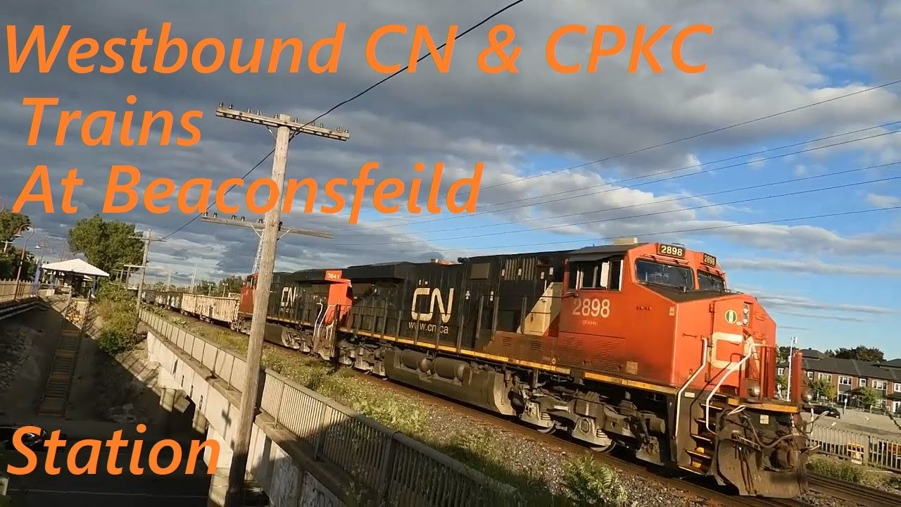8 12 23 WESTBOUND CN & CPKC TRAIN AT BEACONSFEILD STATION IN MONTREAL ...