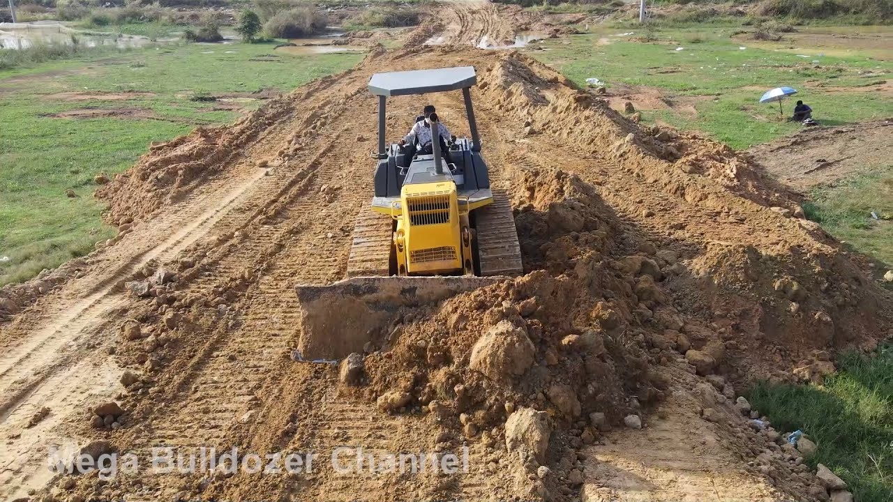 Mighty Bulldozer Operated with Dump Truck to Filling land on the field ...